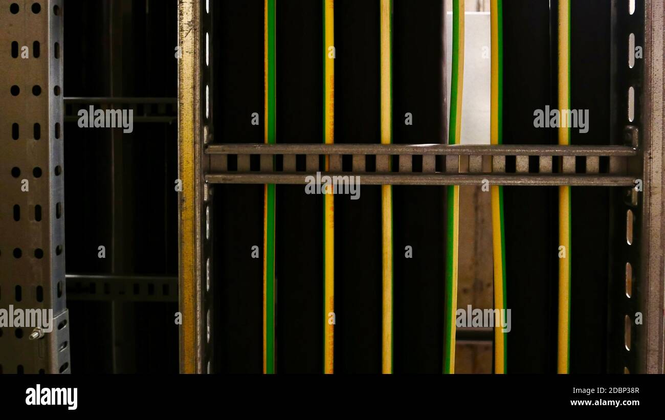 Green and yellow electrical wiring on metal railing Stock Photo - Alamy