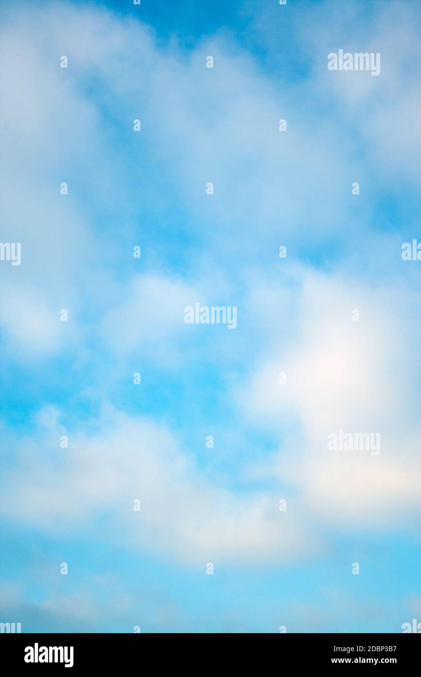 Huge clouds in blue sky lit by the sun, not windy Stock Photo - Alamy