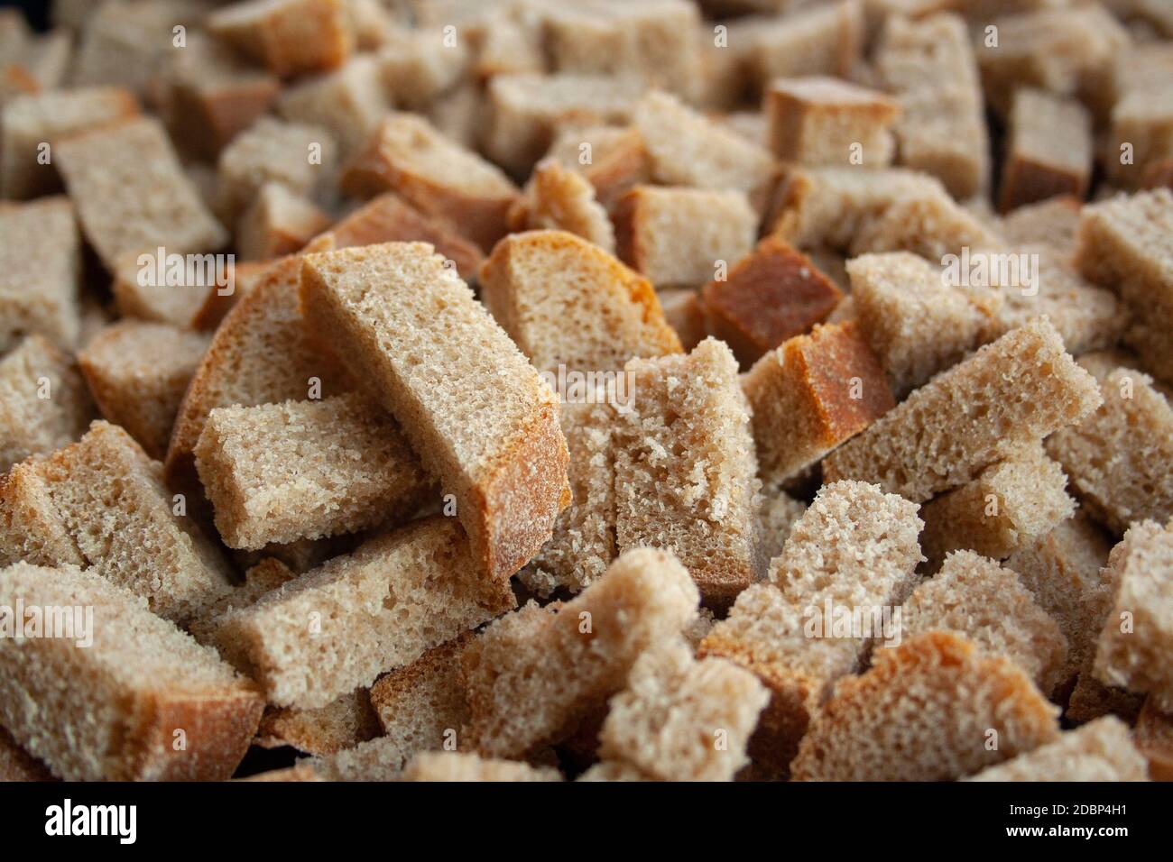 Sliced in cubes dark bread pieces crackers macro shot close up ...