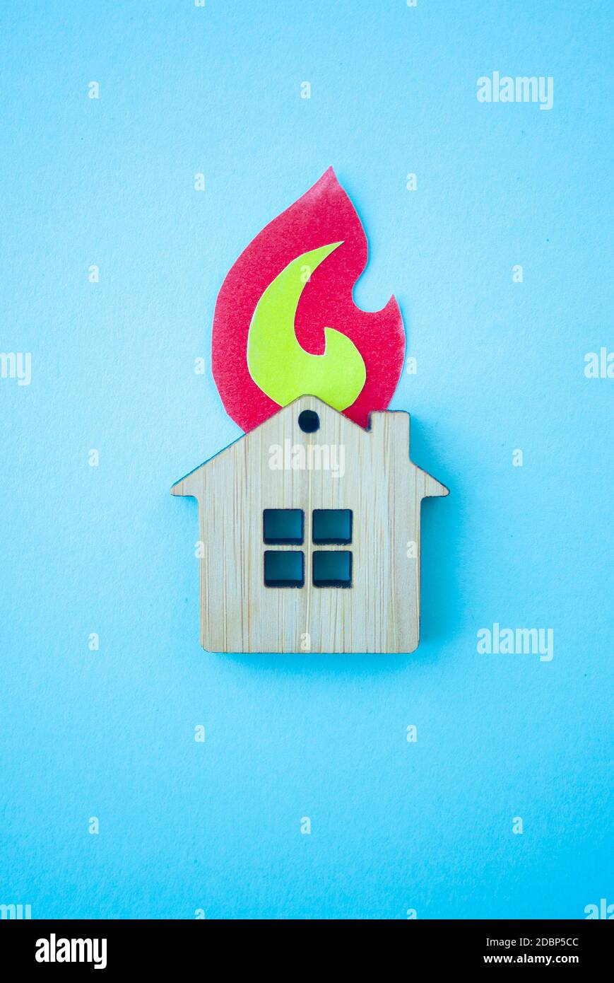 Fire house, insurance and mortgage concept. Small wooden house toy and ...