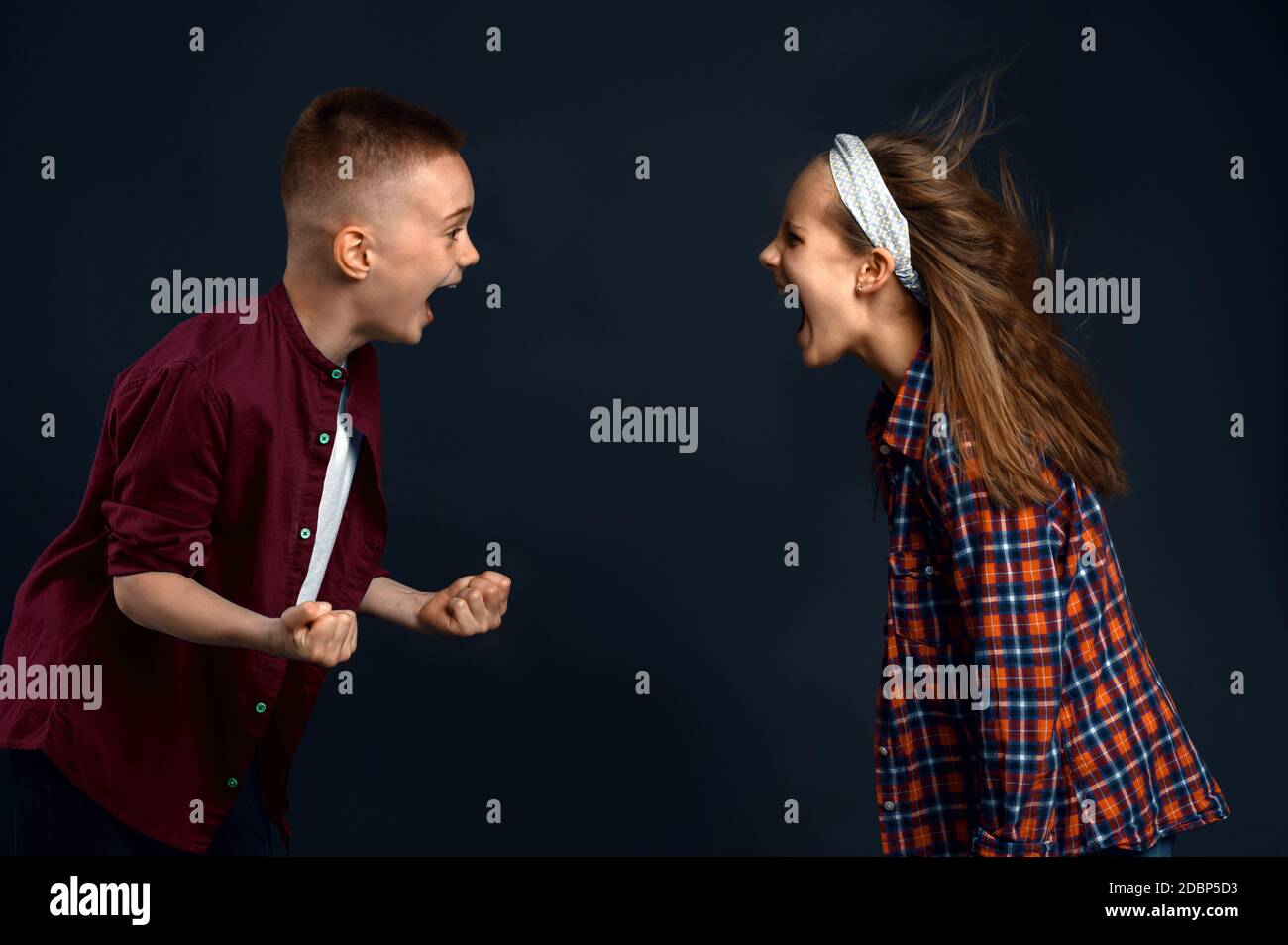 Little boy and girl are shouting at each other in studio, developing ...