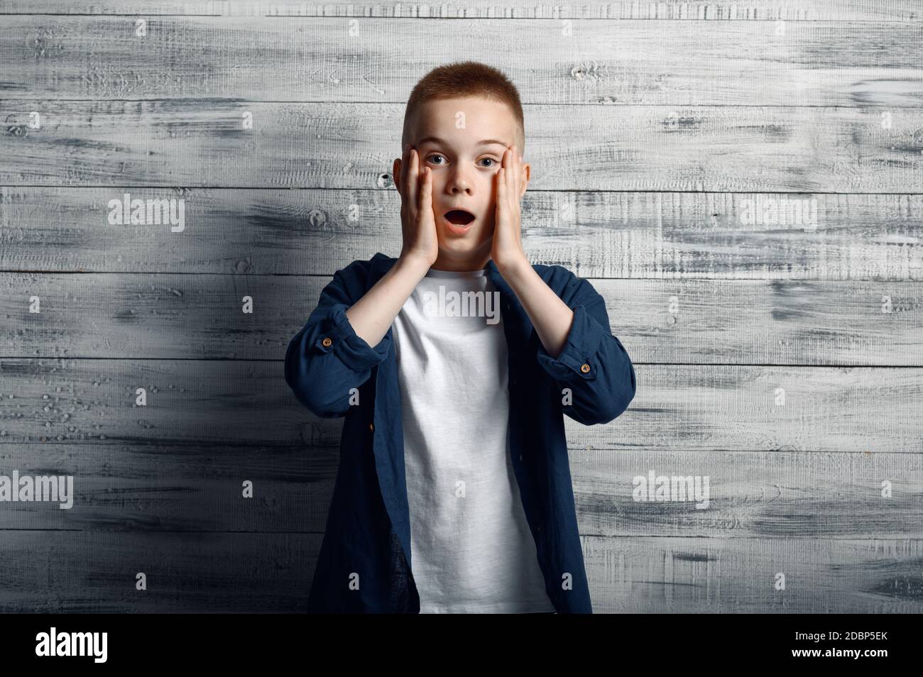 Surprised little boy in studio. Children and gadgets, kid isolated on ...