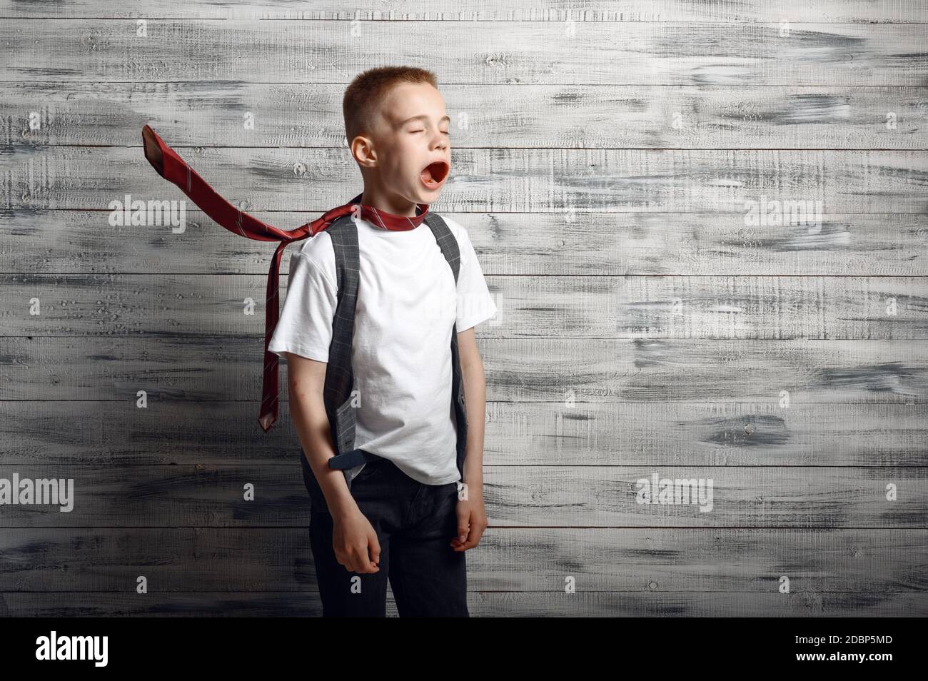 Little boy against powerful airflow in studio, developing hair, windy ...