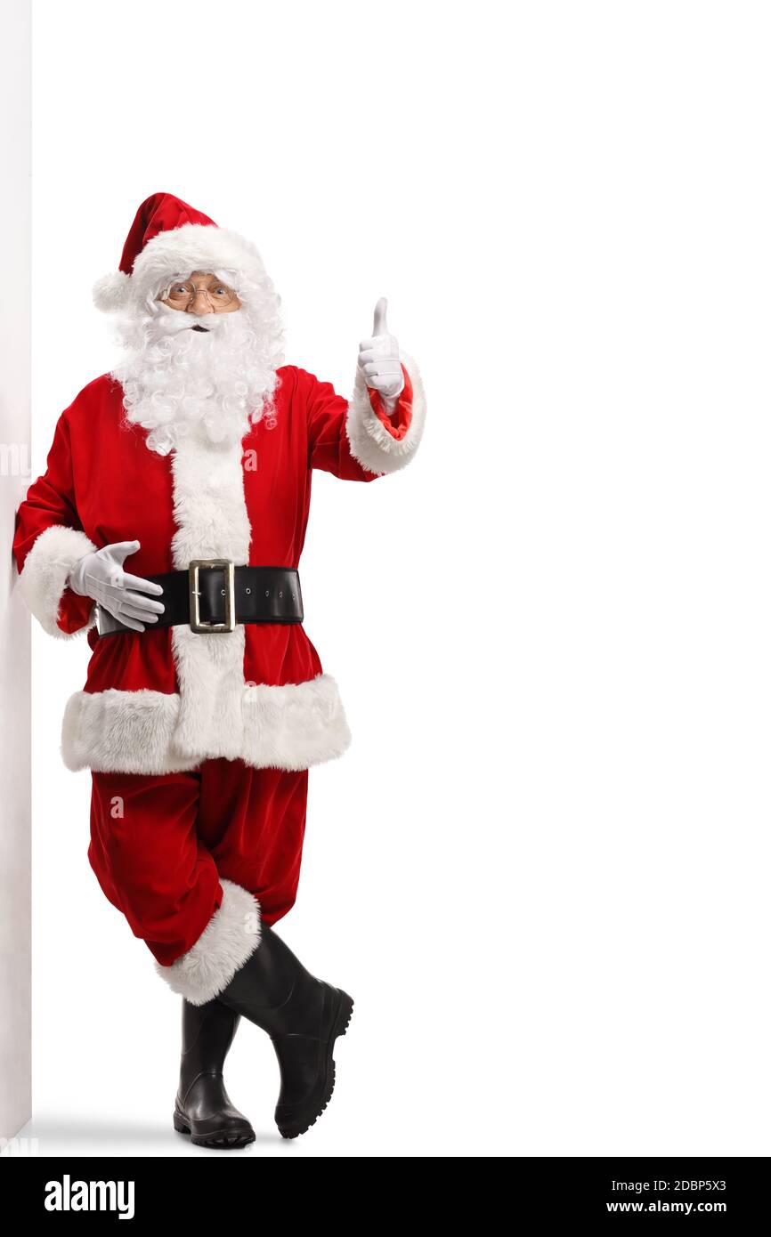 Full length portrait of santa claus leaning on a wall and gesturing a ...