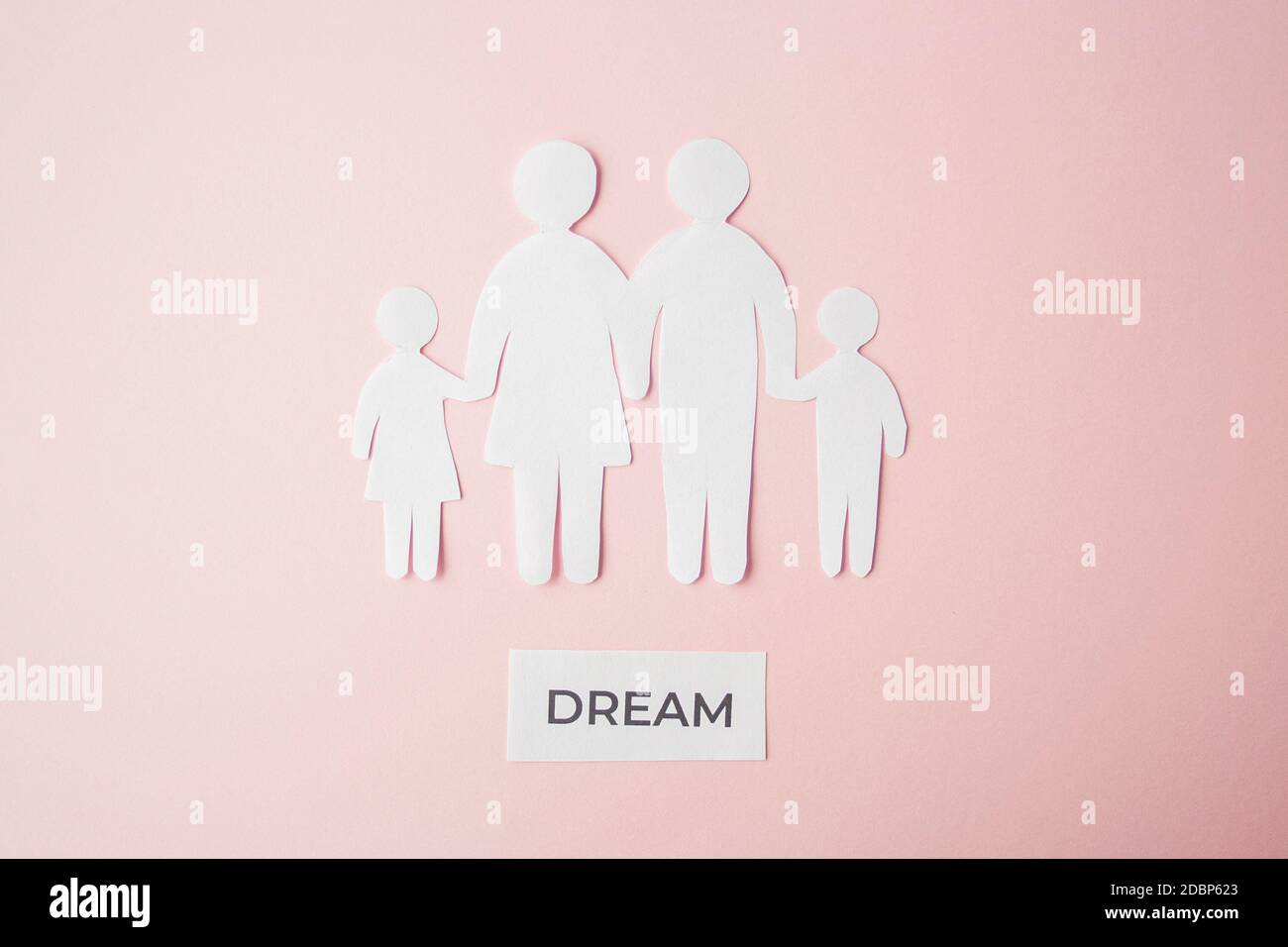 paper family cut out on bright pink background, family home, foster ...
