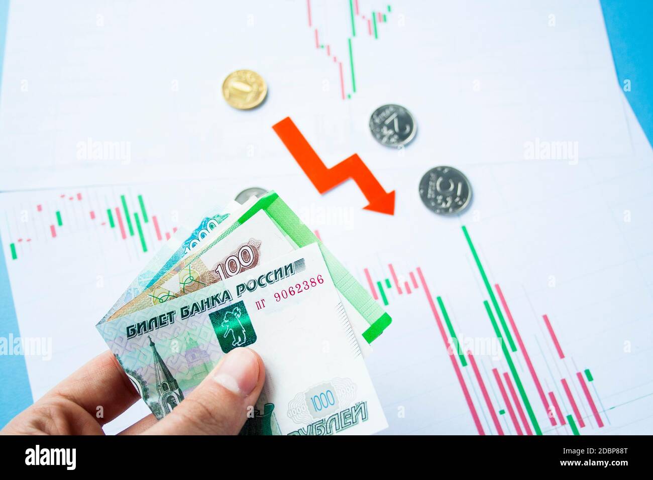 Male hand holding rouble bills on exchange rate of russian ruble and ...