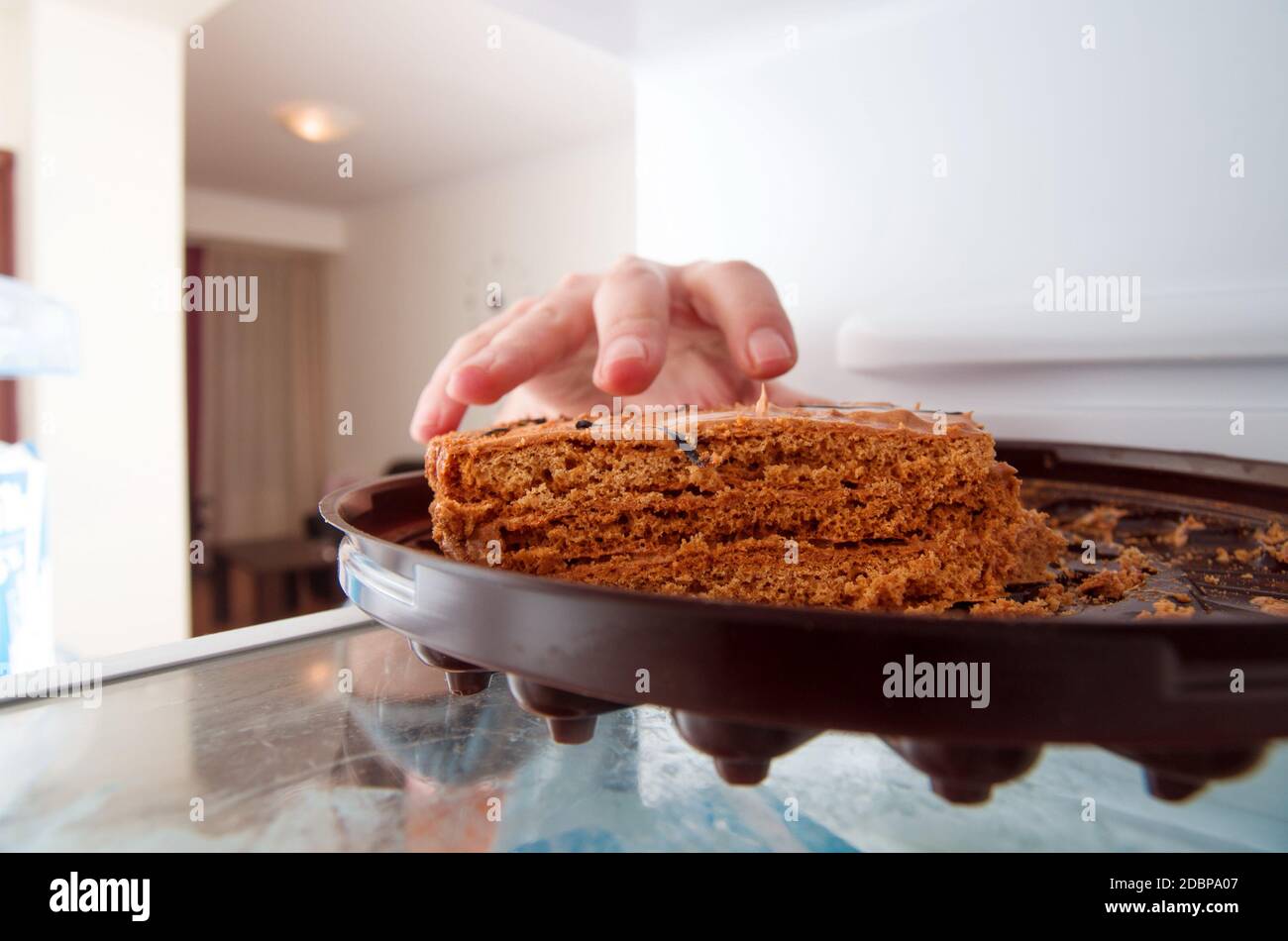 stealing the cake from the fridge Stock Photo - Alamy