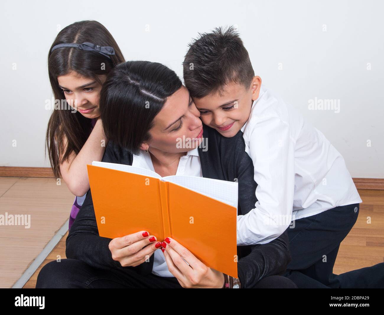 mother with children reading together Stock Photo - Alamy
