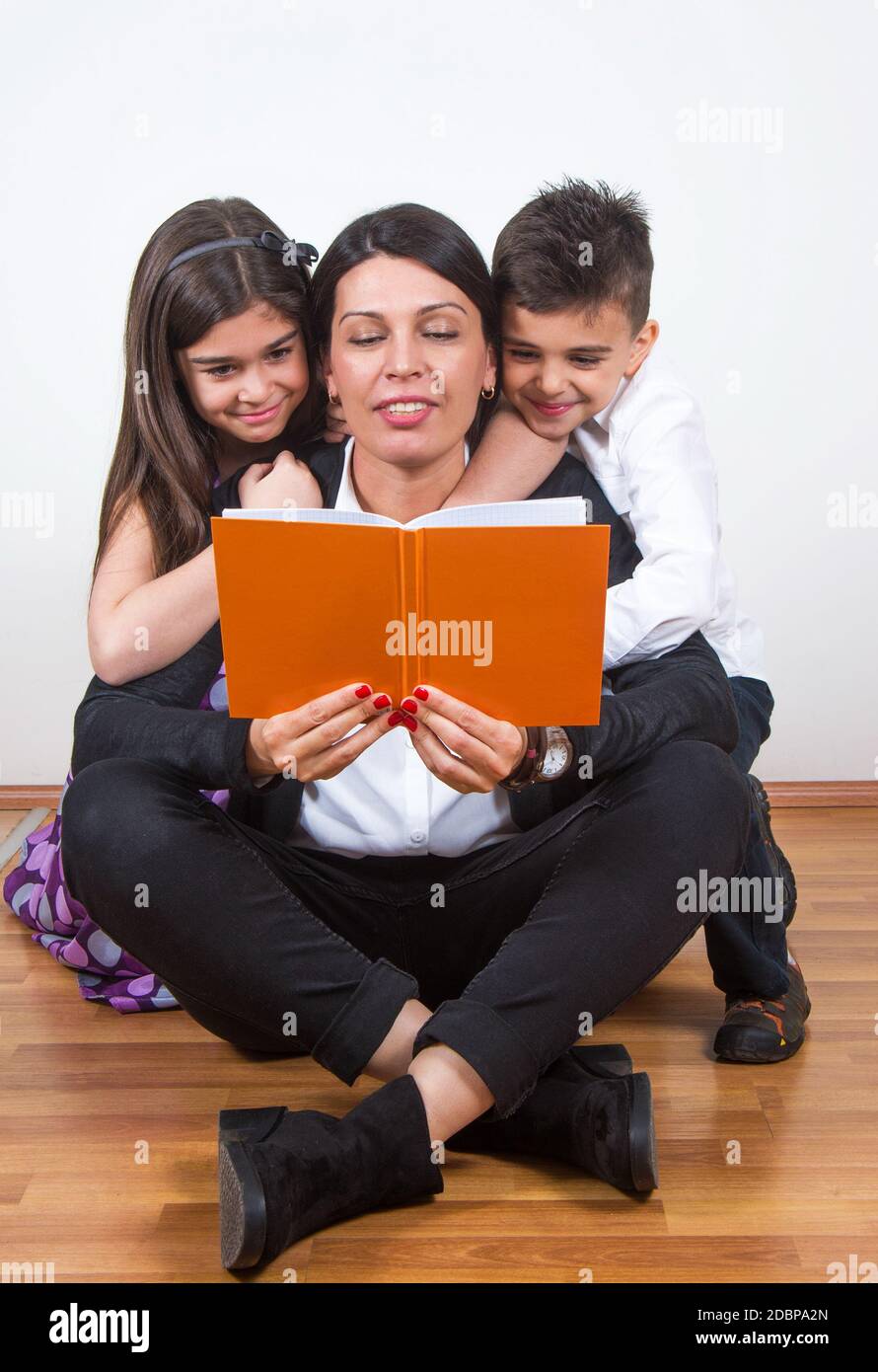 mother with children reading together Stock Photo - Alamy