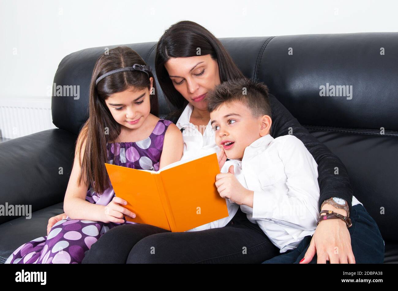 mother with children reading together Stock Photo - Alamy