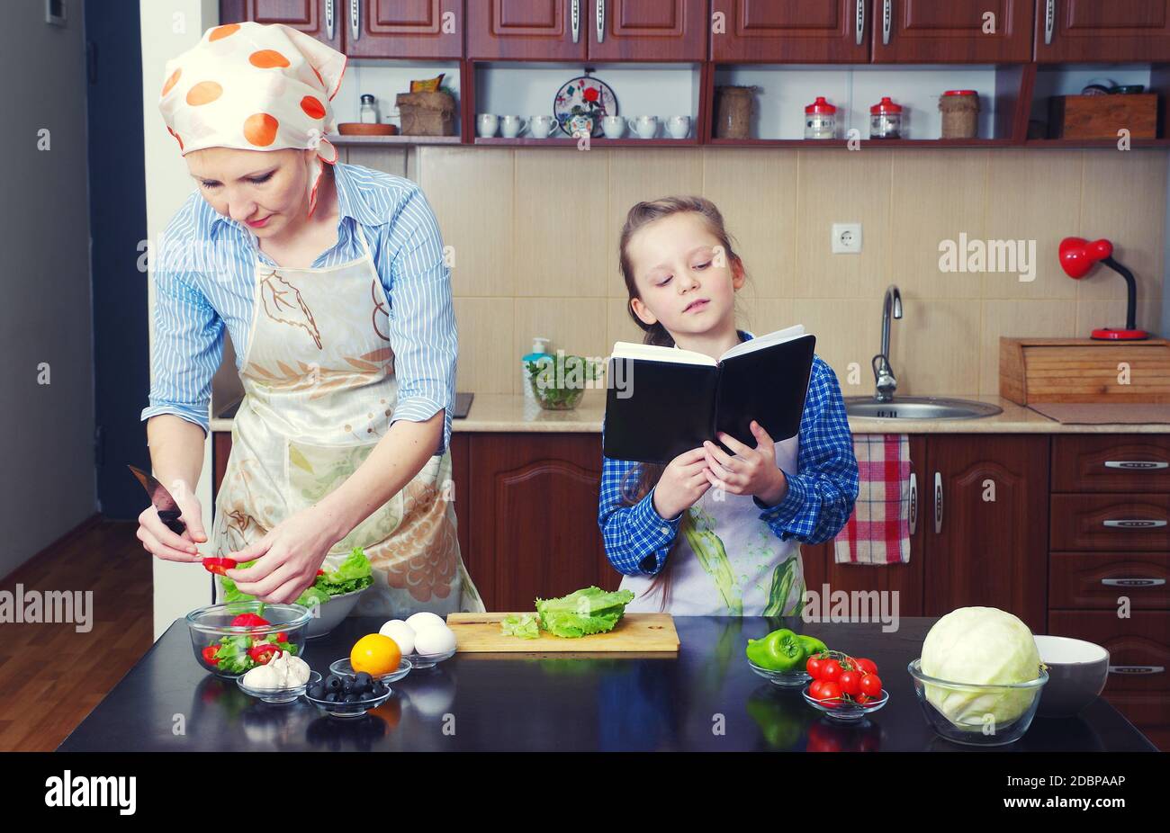 little girl is teaching her mother to cook in a kitchen with different ...