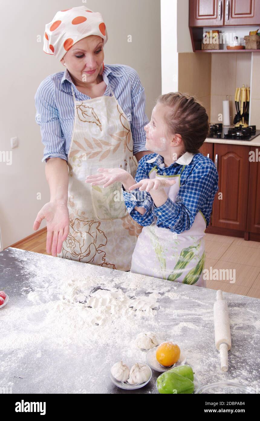 little girl is helping to bake in a kitchen Stock Photo - Alamy