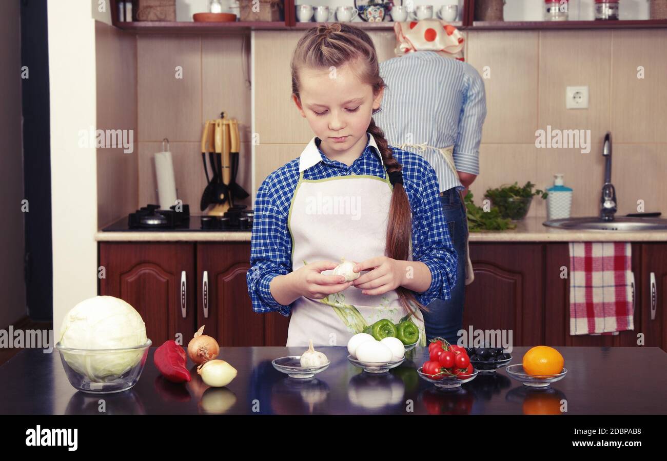 little girl is helping her mother to cook in a kitchen with different ...