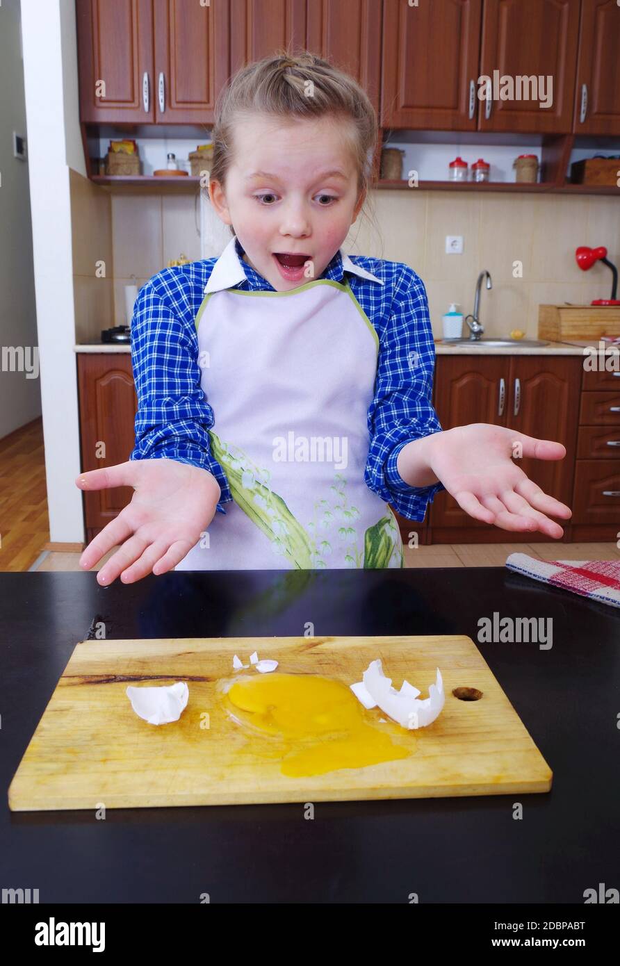 little girl with the broken egg Stock Photo - Alamy