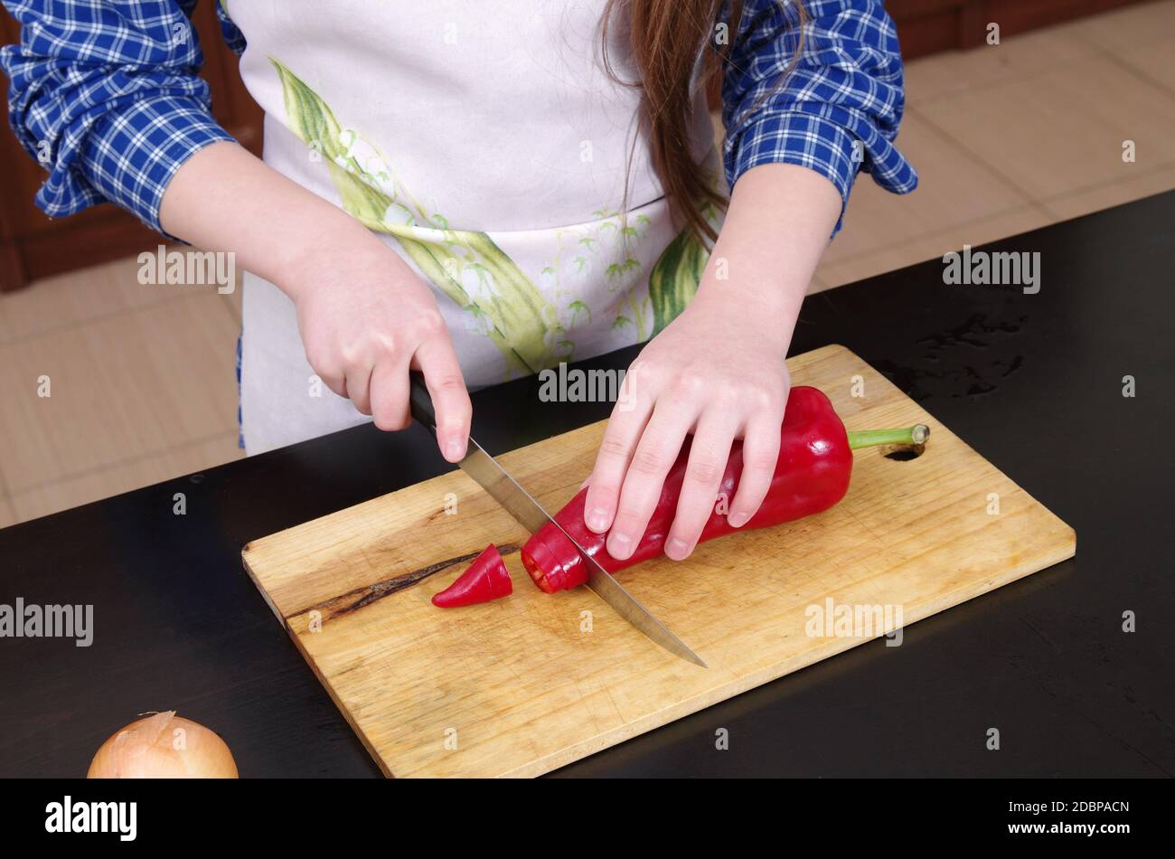Little girl is cutting vegetables for salad closeup Stock Photo - Alamy