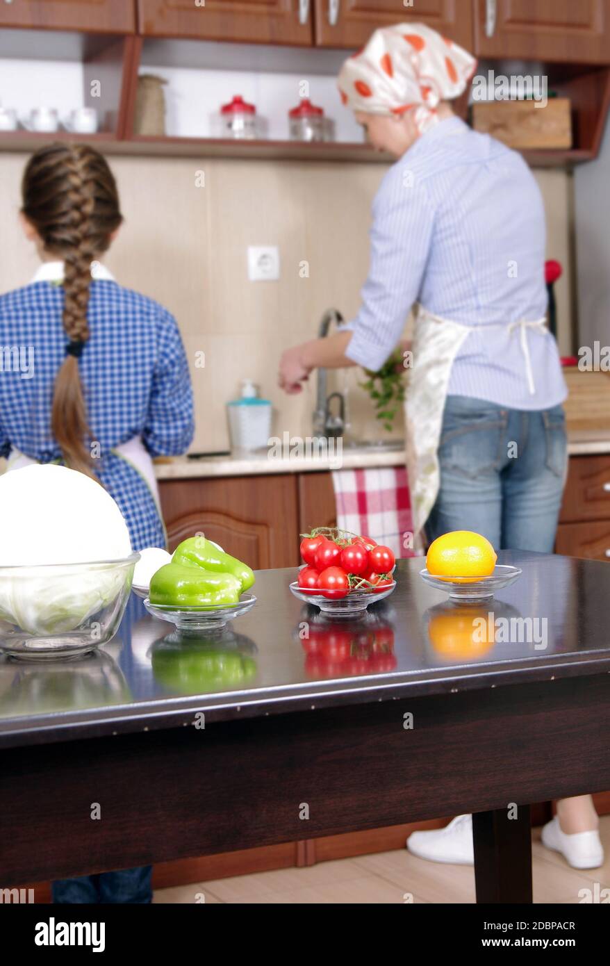 little girl is helping her mother to cook in a kitchen with different ...