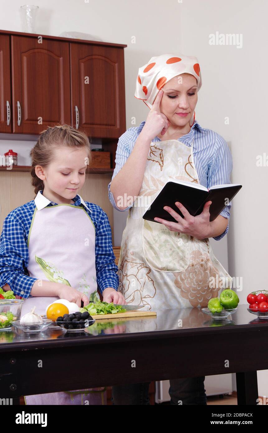 little girl is teaching her mother to cook in a kitchen with different ...