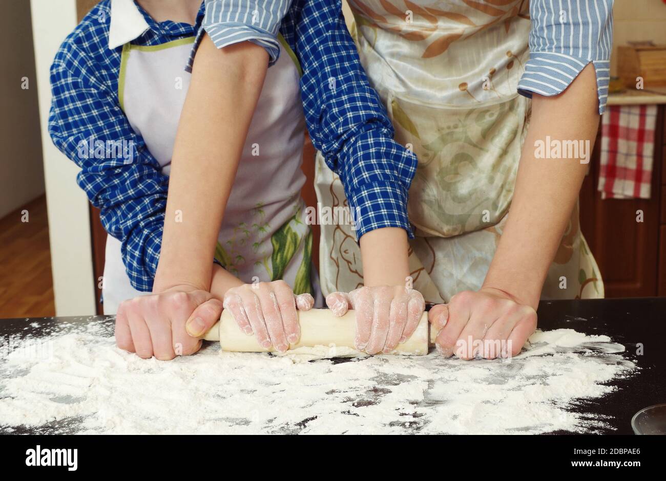 little girl is helping to bake in a kitchen Stock Photo - Alamy