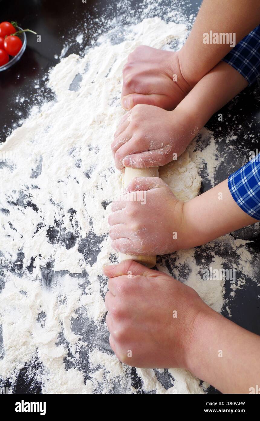little girl is helping to bake in a kitchen Stock Photo - Alamy