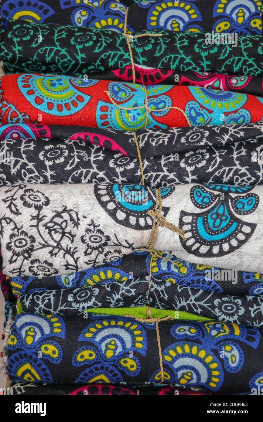 Rolled up colored fabrics tied with string. Shop with brightly colored ...