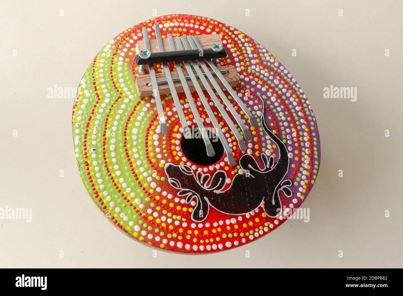 Traditional musical instrument karimba with gecko lizard motif. Close ...