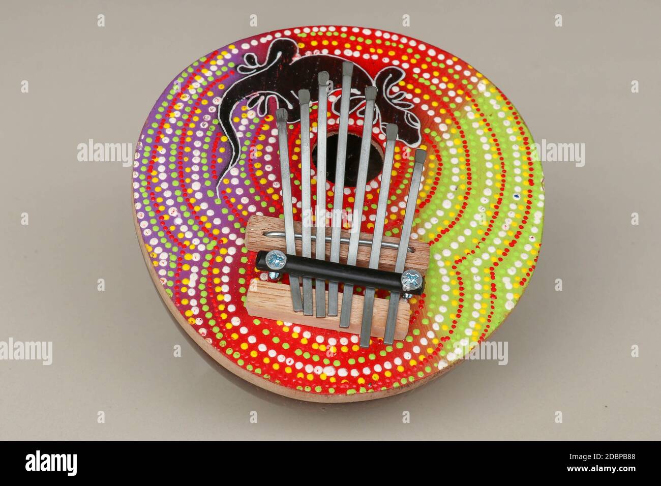 Traditional musical instrument karimba with gecko lizard motif. Close ...
