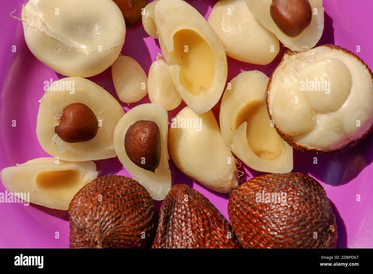 Close up of peeled, cuted and whole pieces of Snake fruit with seed ...
