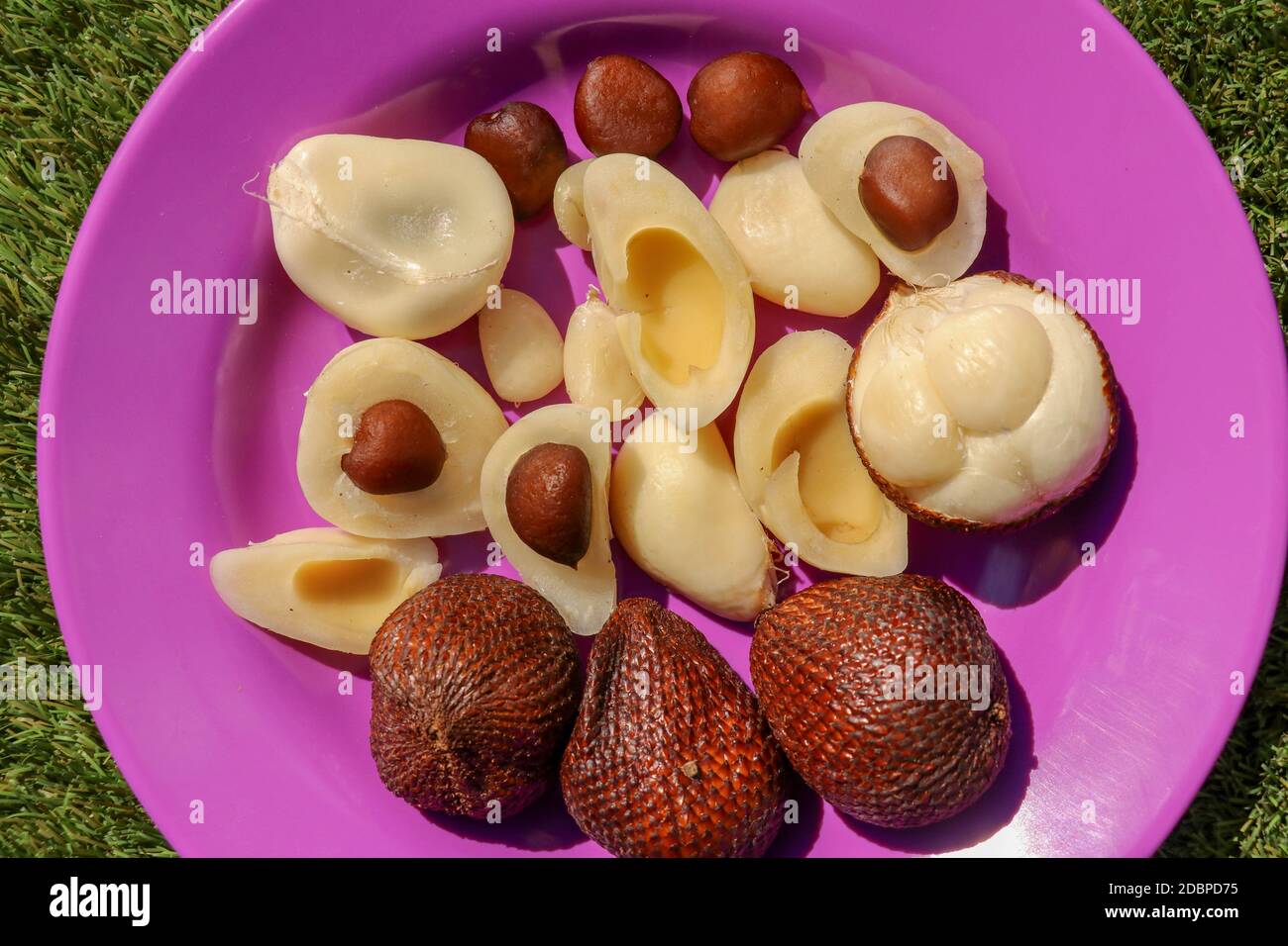 Close up of peeled, cuted and whole pieces of Snake fruit with seed ...