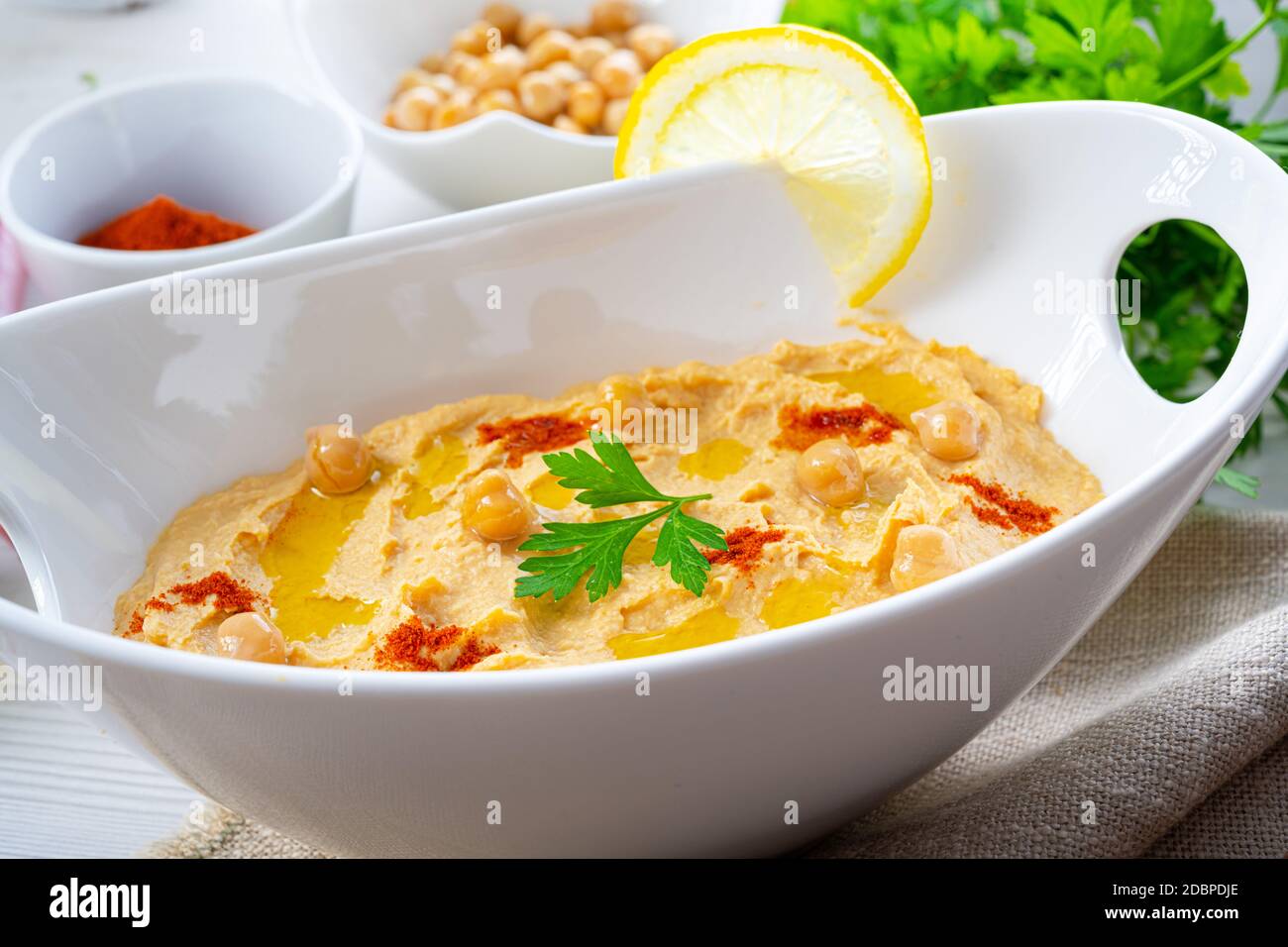 hummus paste with lemon and chilli on white background Stock Photo - Alamy