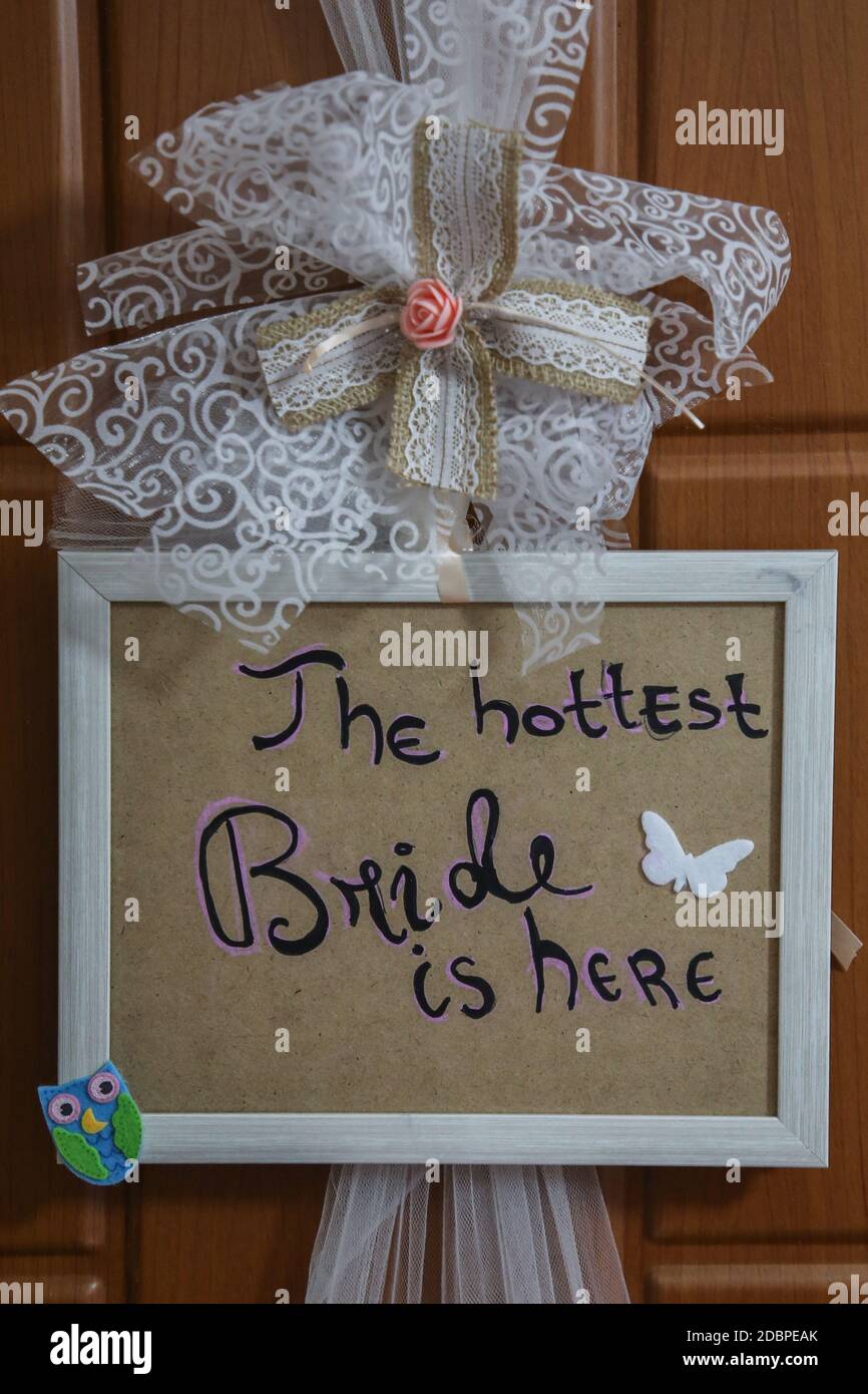 THE HOTTEST BRIDE IS HERE, an inscription written on the bride's door ...
