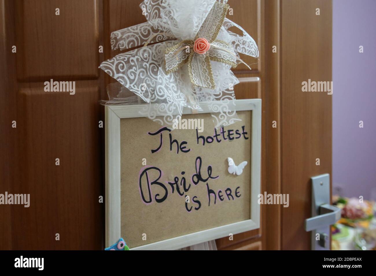 THE HOTTEST BRIDE IS HERE, an inscription written on the bride's door ...