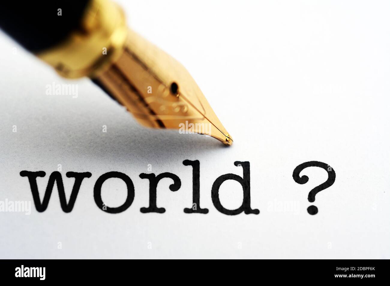 Fountain pen on world text Stock Photo - Alamy