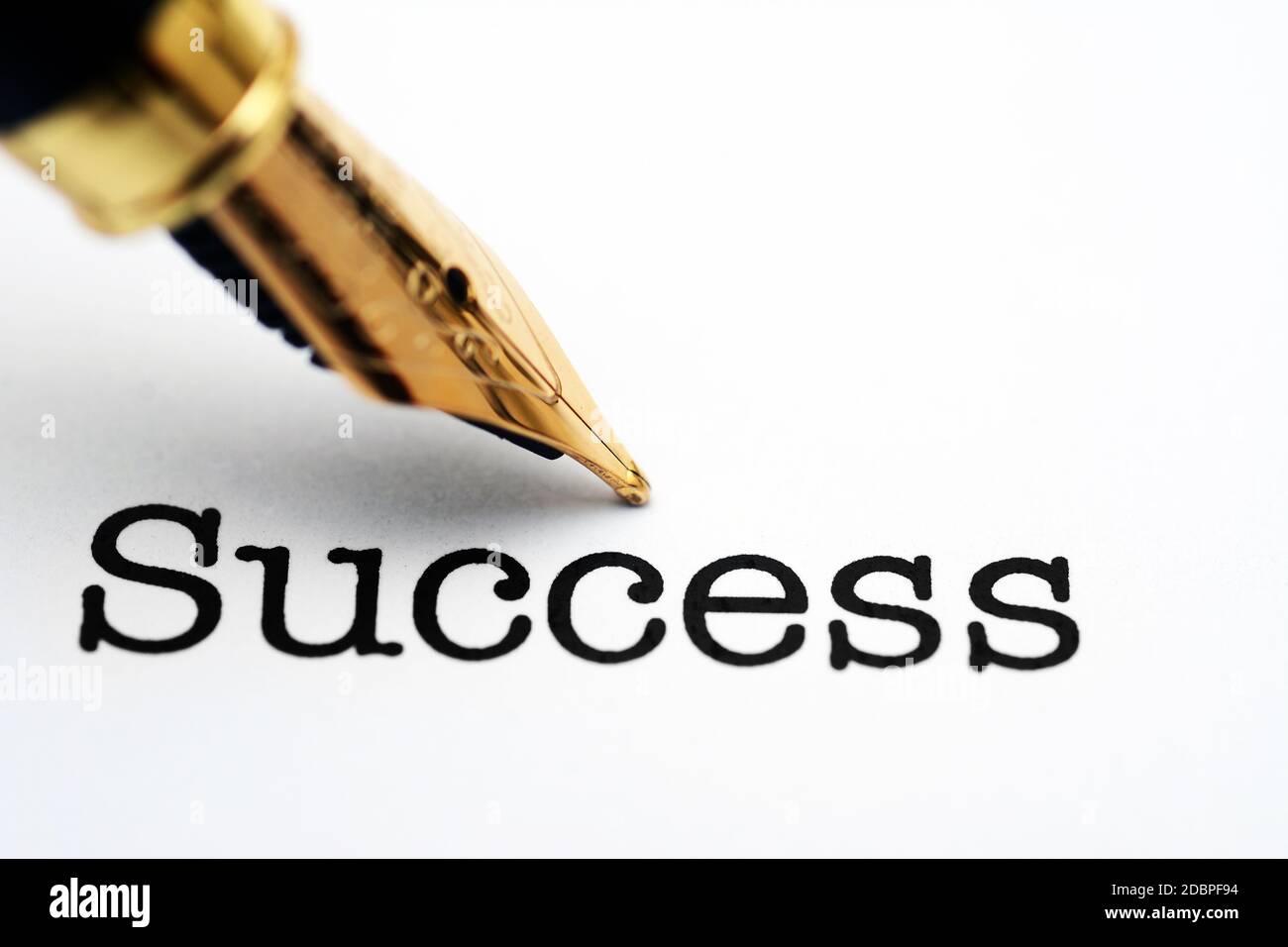 Fountain pen on success text Stock Photo - Alamy