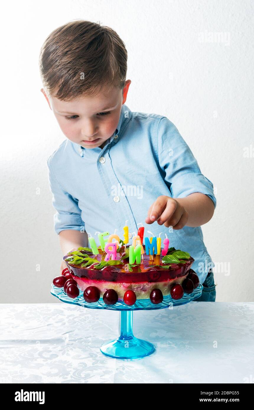 Little boy with the birthday cake Stock Photo - Alamy
