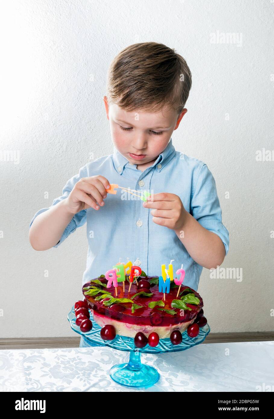 Little boy with the birthday cake Stock Photo - Alamy