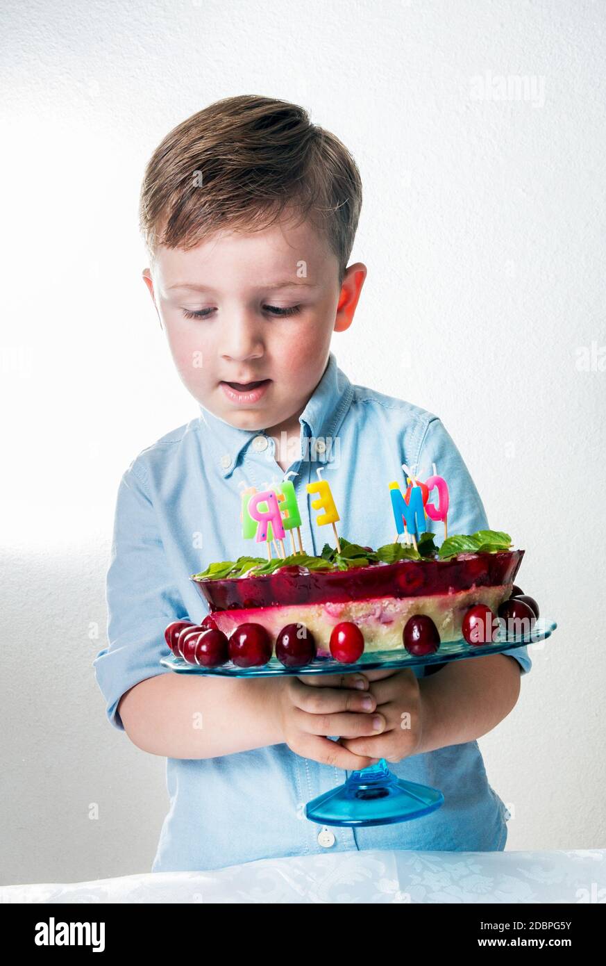 Little boy with the birthday cake Stock Photo - Alamy