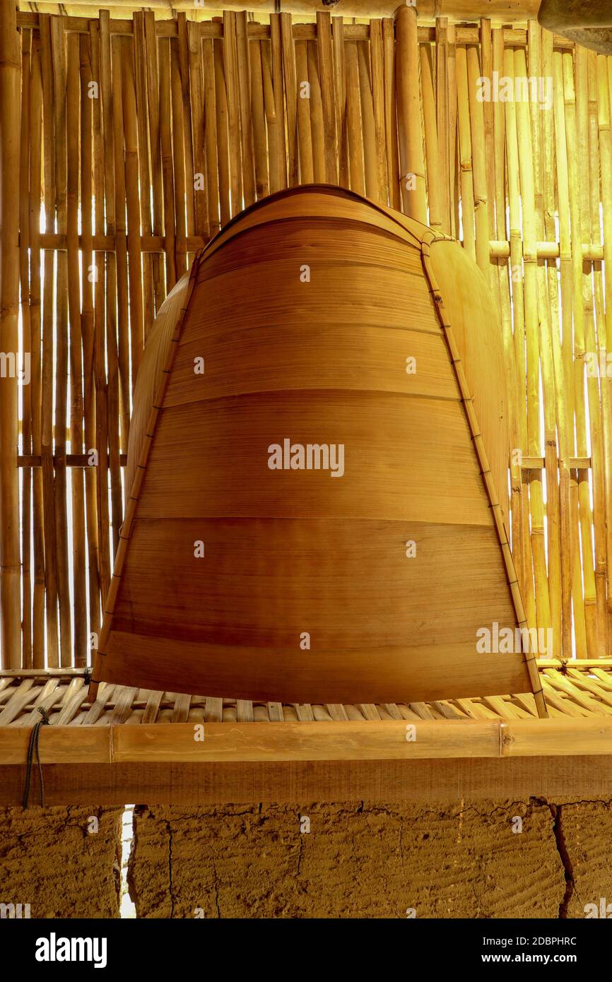 A long hat of dry palm leaves used by planters in paddy fields as an ...