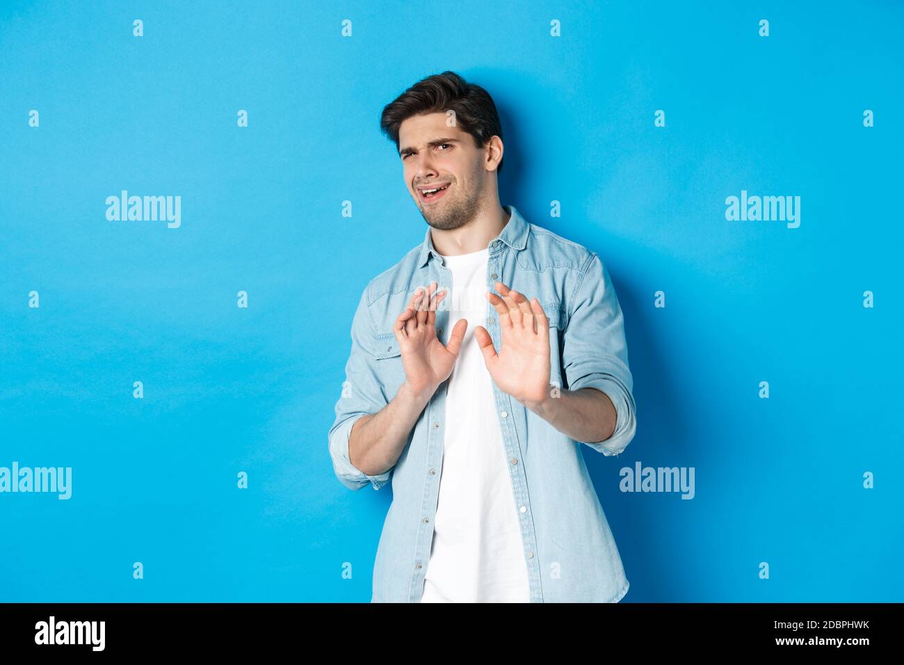 Displeased man refusing, saying no and cringe from something disgusting ...