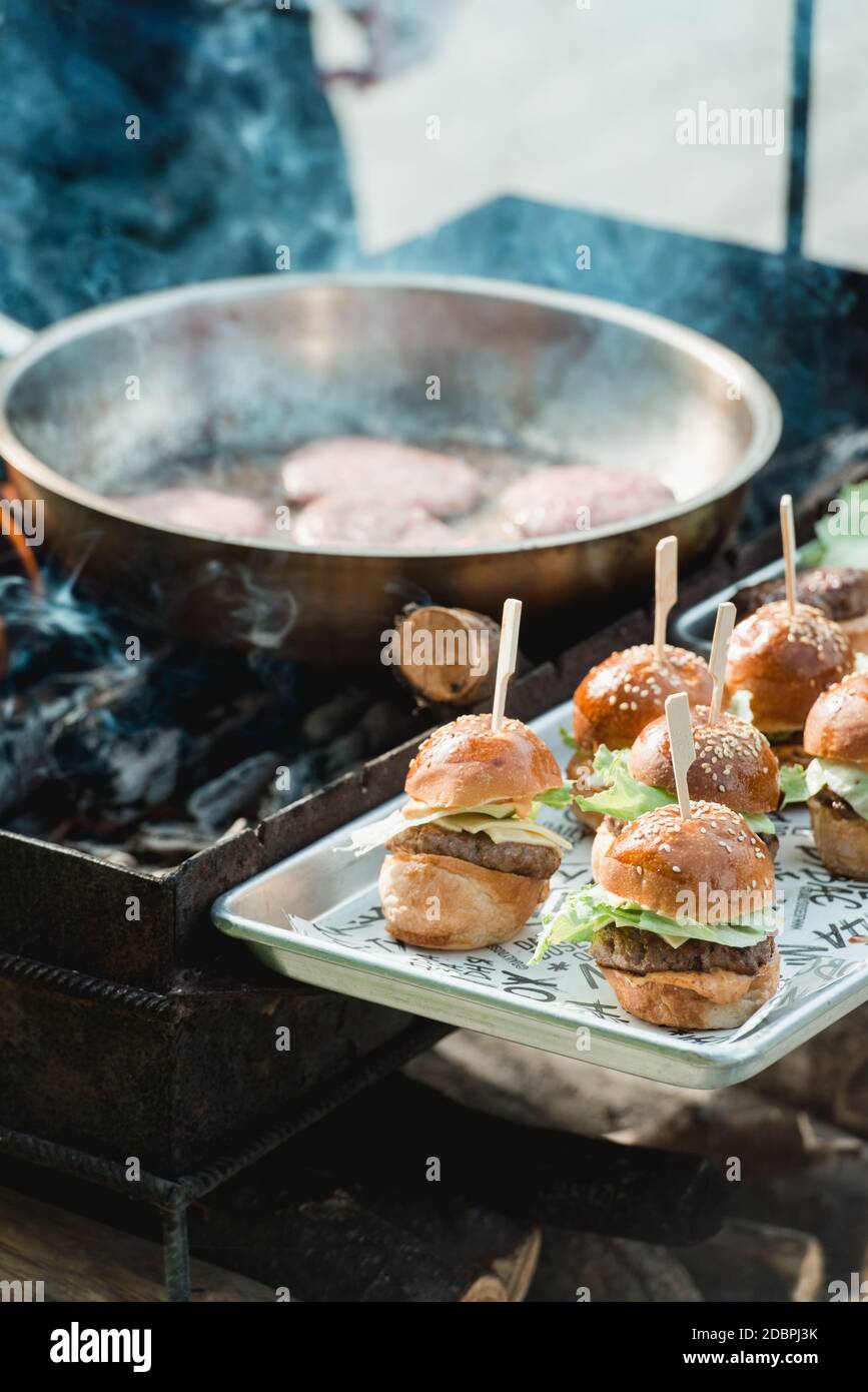 Chef making beef burgers outdoor on open kitchen food festival event ...