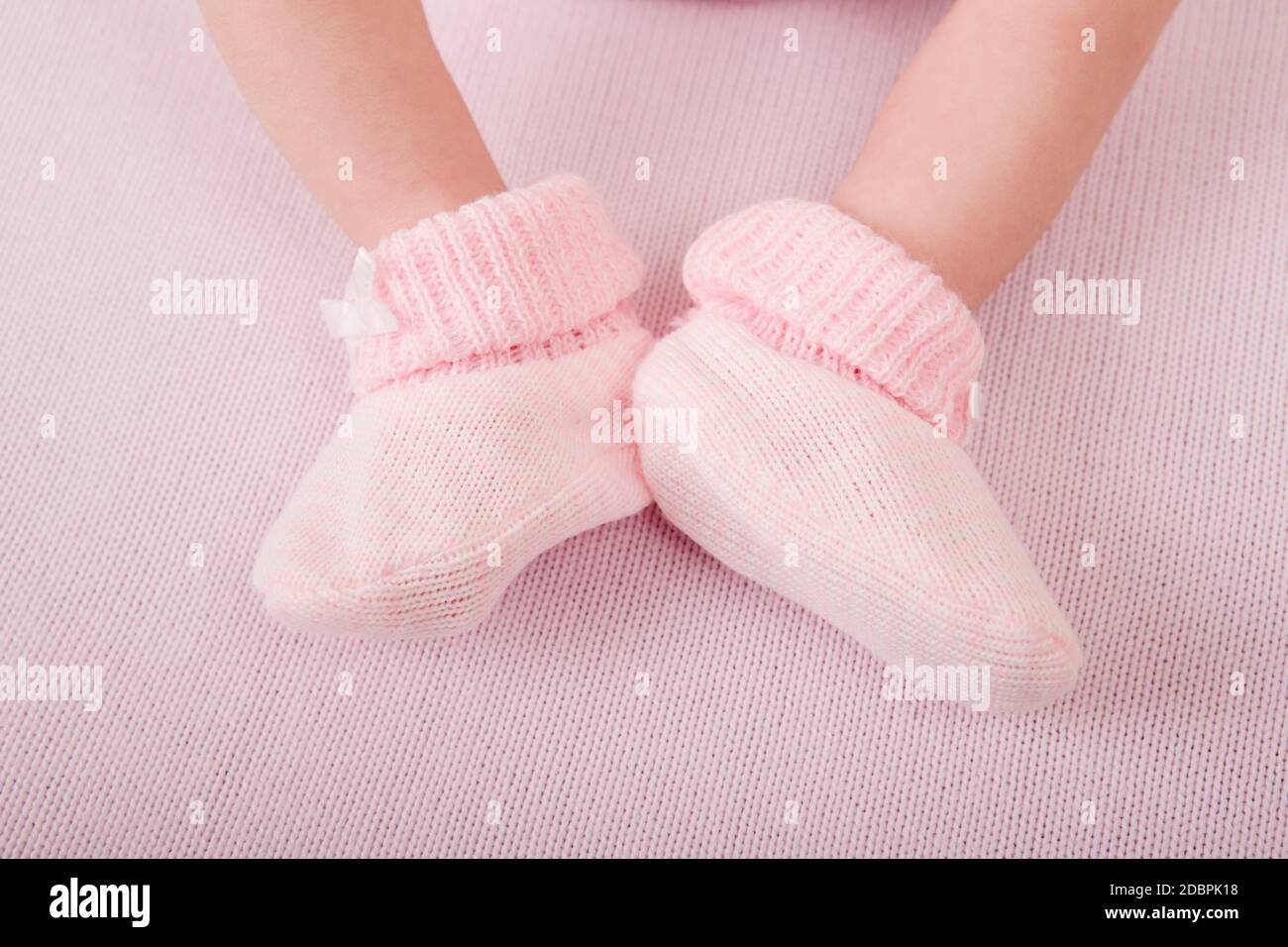 Newborn baby feet close up. Baby feet in white terry socks, baby lying ...