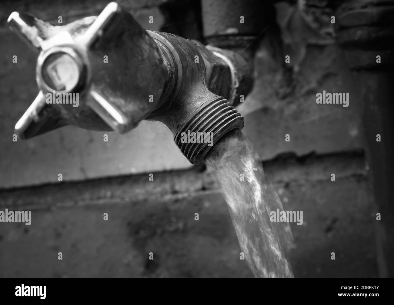 Old outdoor tap with running water Stock Photo - Alamy