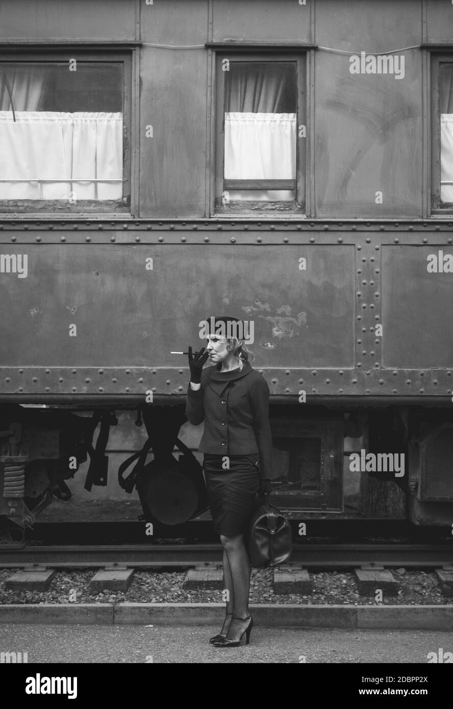 Retro woman on the train station Stock Photo - Alamy