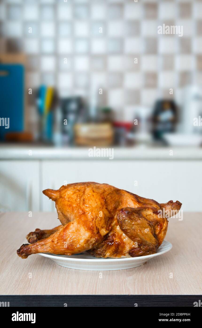 Roasted chicken on the plate in kitchen Stock Photo - Alamy