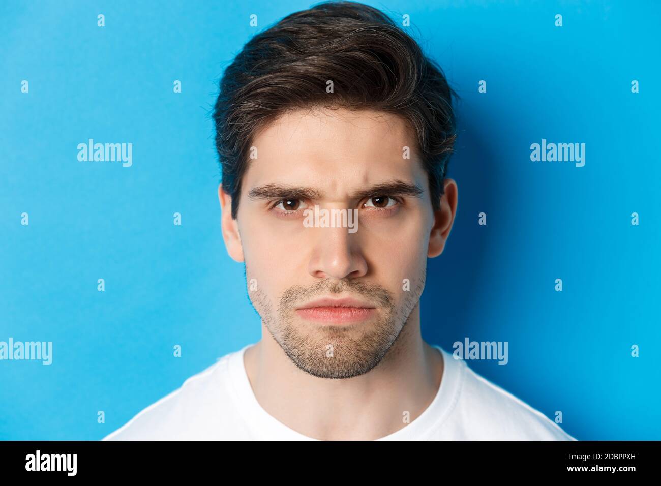 Headshot of angry man frowning, looking disappointed and bothered ...