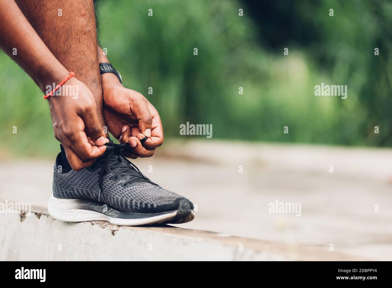 Close up Asian sport runner black man wear watch stand step on the ...