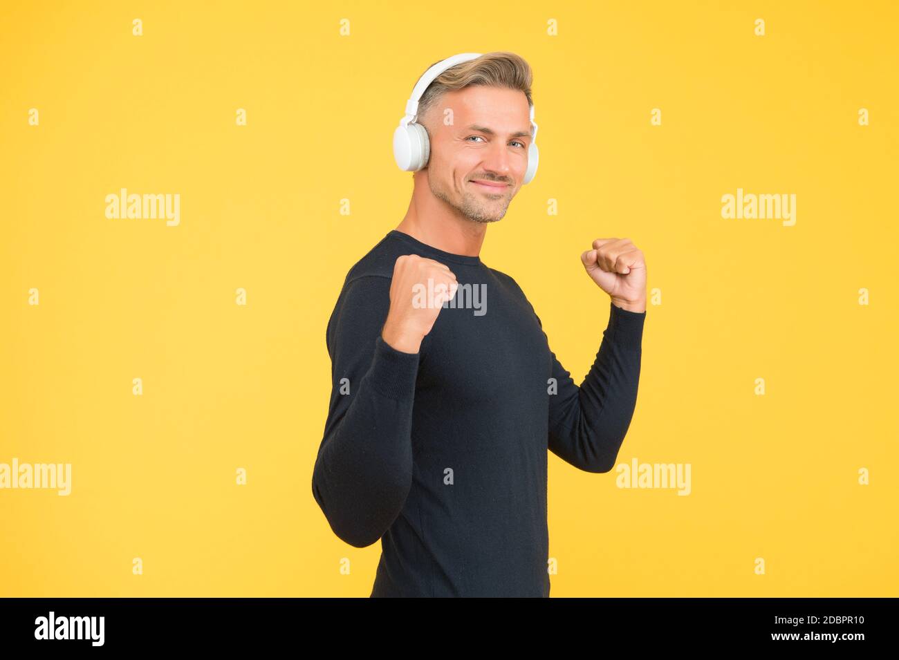 handsome happy male with nice smile demonstrate high quality headset ...