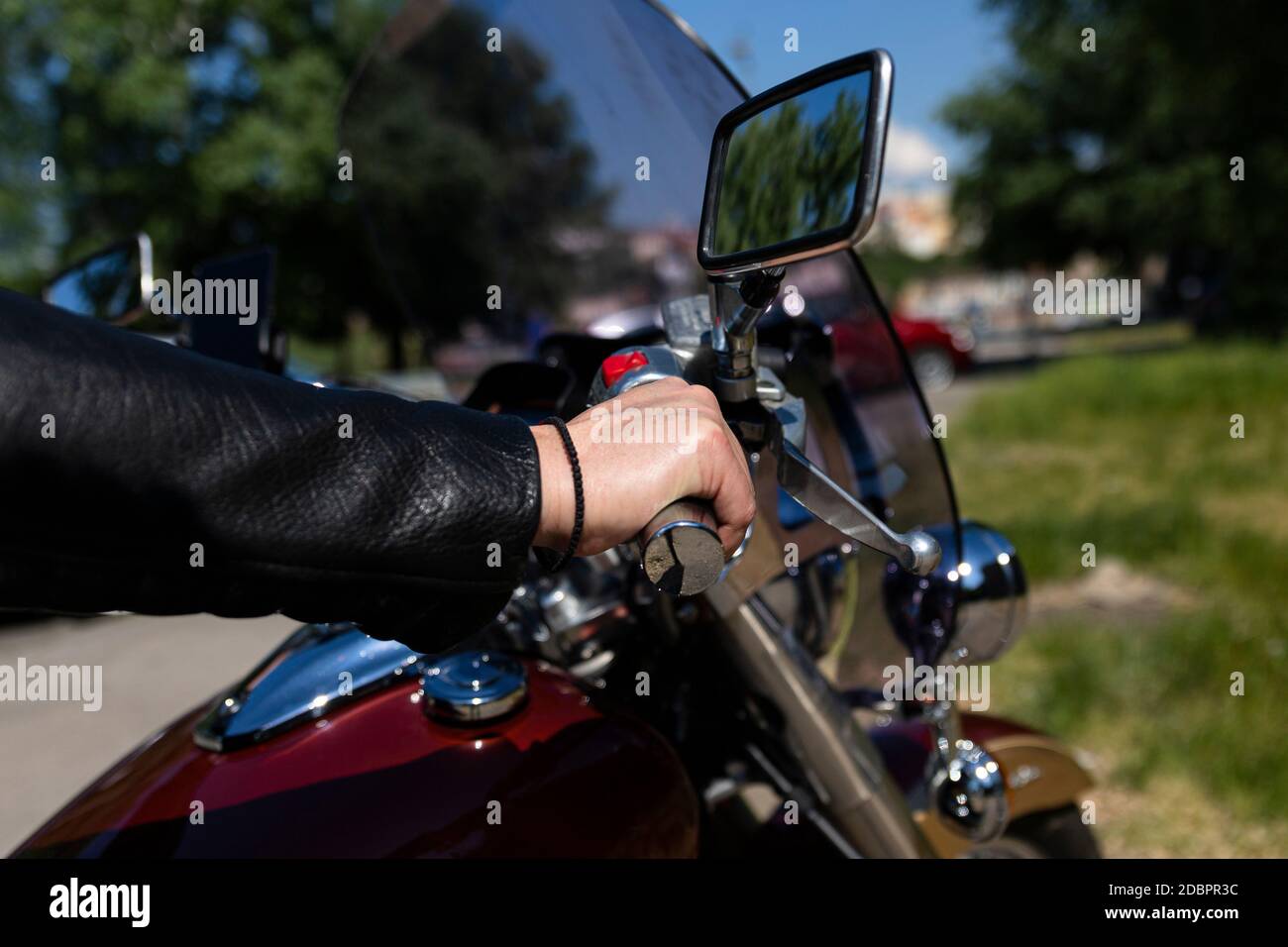 Biker riding on a motorcycle. View of a hand on handlebar giving gas ...
