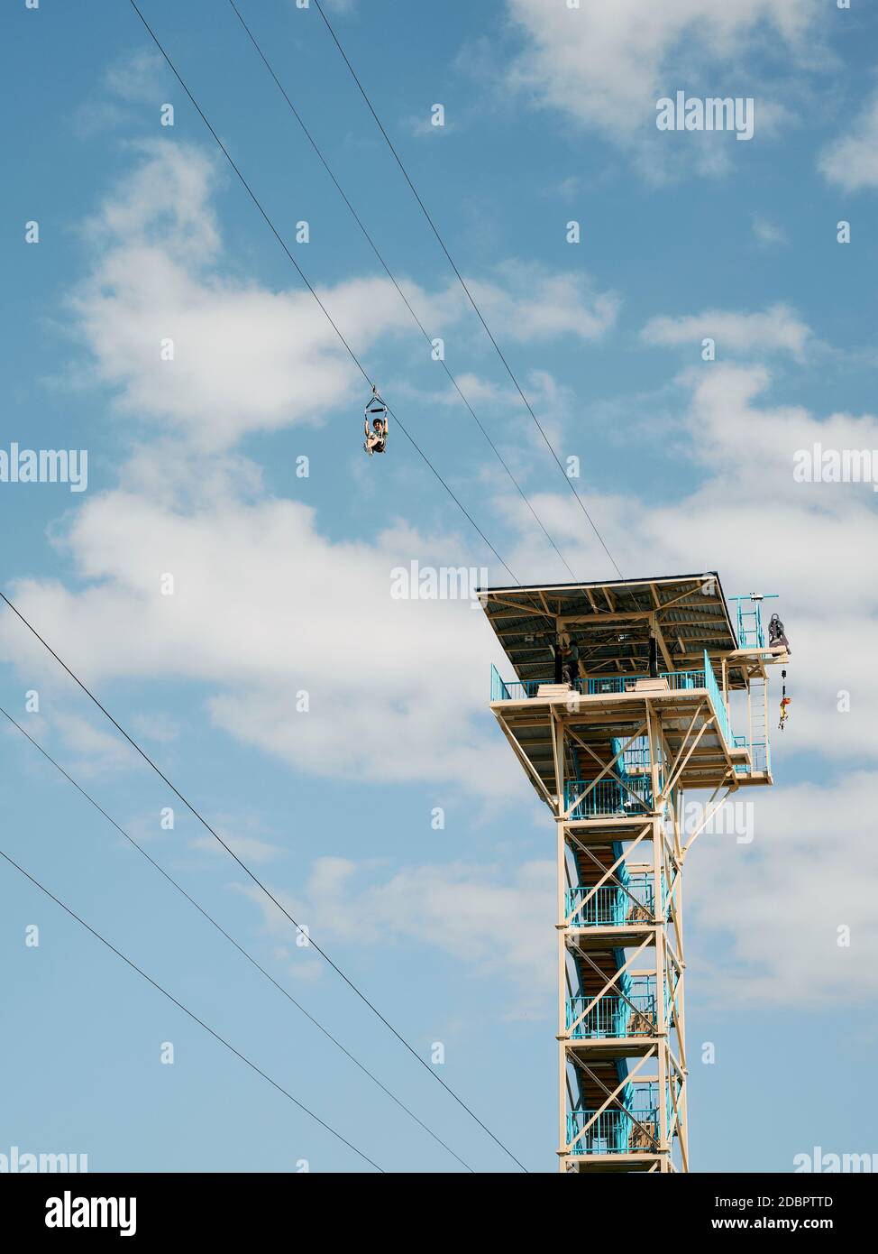 Child high up on a recreational zip line at the family resort ...