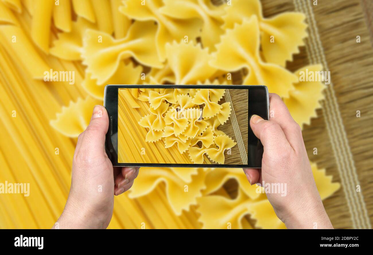 Taking picture with the phone. Pasta Stock Photo - Alamy