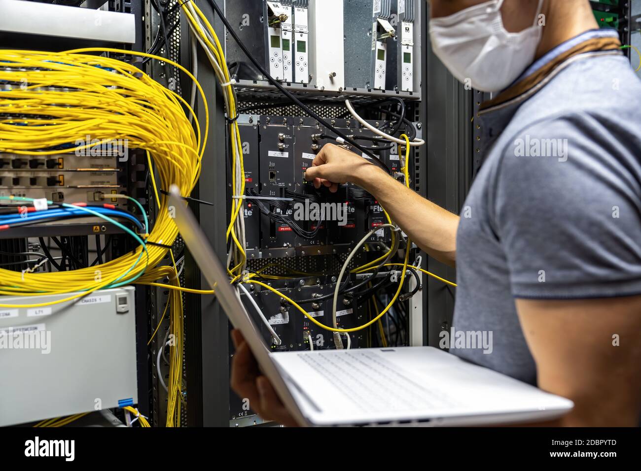 Technician engineer fixing problem with servers and data in cables room ...
